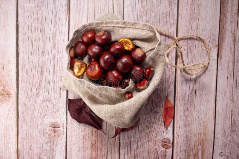 Fresh Chestnuts in Linen Bag on the Wood Background. Stock Photo ...