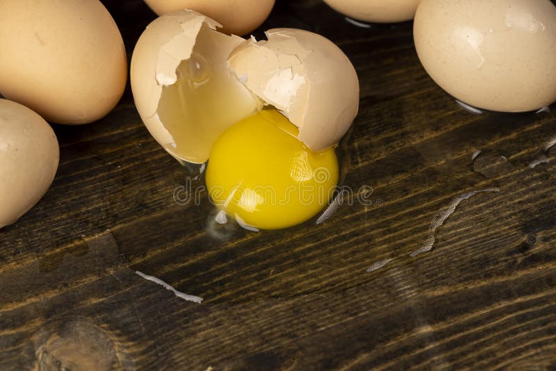 A Fresh Egg Smashed on a Black Table, a Broken Cracked Chicken Egg ...