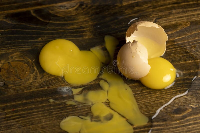A Fresh Chicken Egg Smashed on a Black Table Stock Image - Image of ...