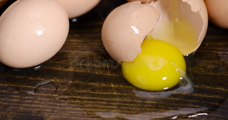 A Fresh Chicken Egg Smashed on a Black Table Stock Video - Video of ...