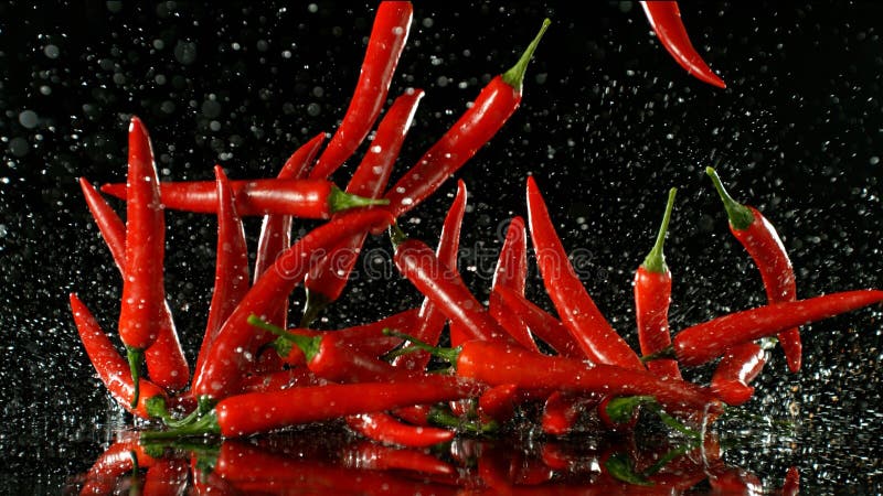Fresh Chilli Peppers Falling Down on Black Background Stock Photo ...
