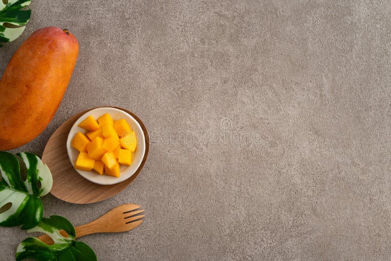 Fresh Chopped, Diced Mango Cubes on Gray Table Background with Tropical ...
