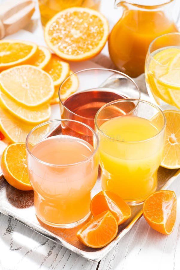 Fresh Citrus Juices on White Table, Vertical Top View Stock Photo ...