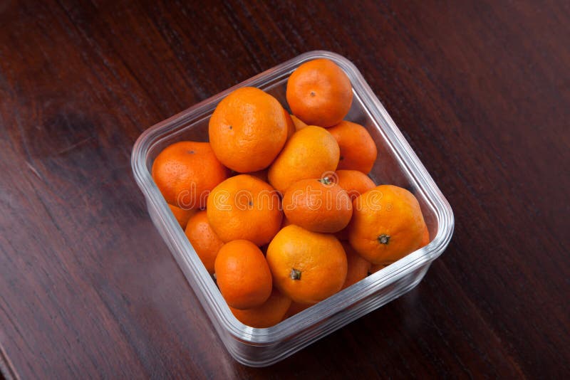 Fresh Clementines Fruit with Glass Bowl on Wood Table Stock Photo ...
