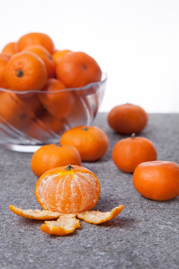 Fresh Clementines Fruit Peeled with Glass Bowl in Vertical Stock Photo ...