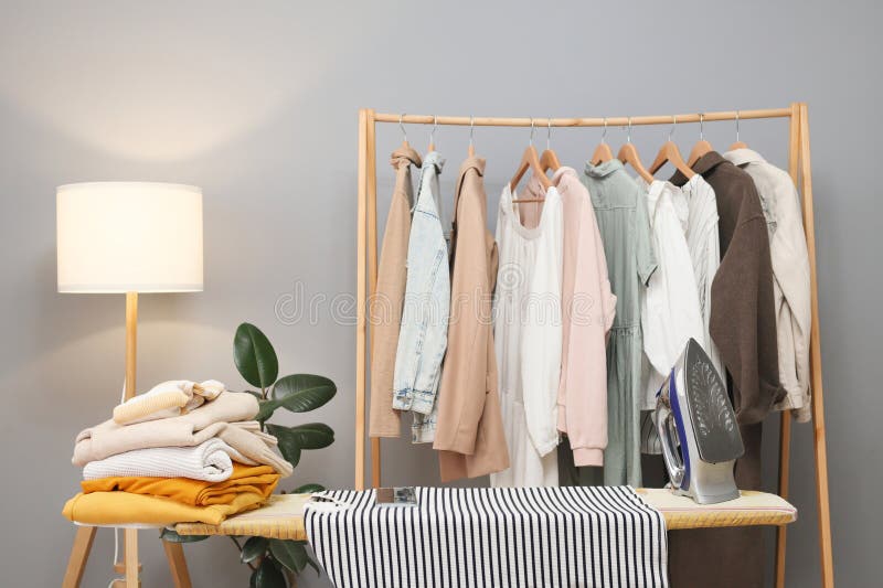 Fresh Clothes on Hangers and on Ironing Board Empty Working Space for ...