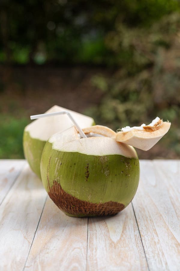 Fresh Coconut Ready To Drink on the Wooden Table Stock Photo - Image of ...