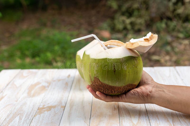 Fresh Coconut Ready To Drink on the Wooden Table Stock Image - Image of ...