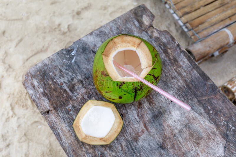 Fresh coconut with a straw stock photo. Image of diet - 107266126