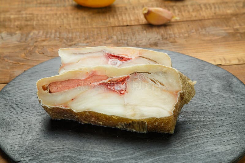 Fresh Cod Fish Steaks on a Black Round Board Stock Photo - Image of ...