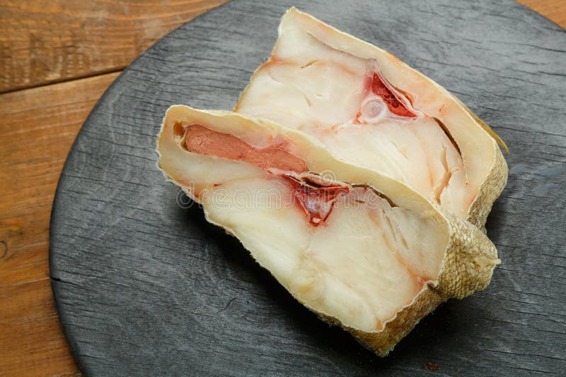 Fresh Cod Fish Steaks on a Black Round Board. Stock Image - Image of ...