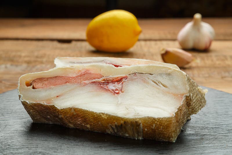 Fresh Cod Fish Steaks on a Black Wooden Board. Stock Photo - Image of ...
