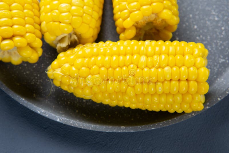 Fresh Cooked Yellow Corn Cobs Lie on a Gray Dish Stock Photo - Image of ...
