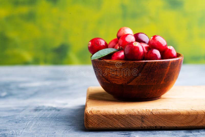 Fresh Cranberries in a Wooden Bowl with Spoon on Dark Wooden Table ...