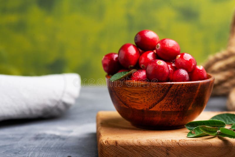 Fresh Cranberries in a Wooden Bowl with Spoon on Dark Wooden Table ...