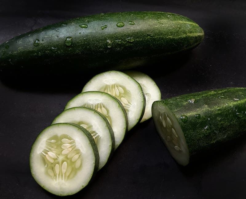 Fresh Cucumber Slices on a Black Background Stock Photo - Image of leaf ...