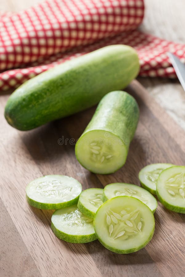 Slices of Cucumber on Wood Cutting Board. Stock Photo - Image of ...