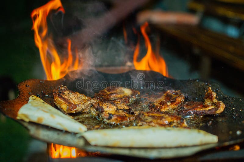 Fresh Cut Bacon Being Cooked Over a Campfire. Meat in a Frying Pan Over ...