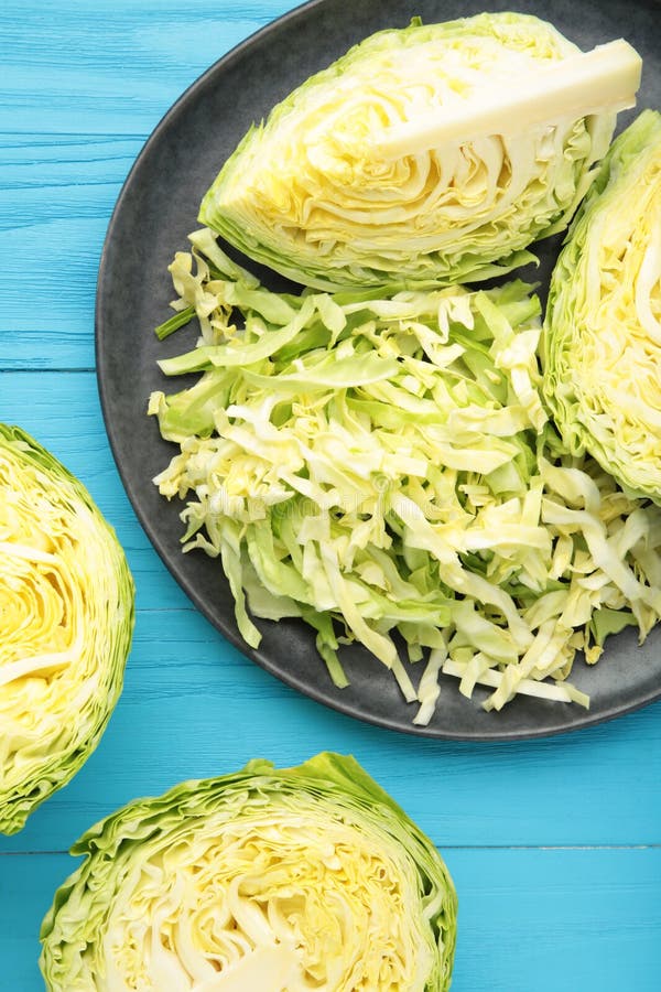 Fresh Cut Cabbages on Plate on Blue Background. Vertical Photo Stock ...