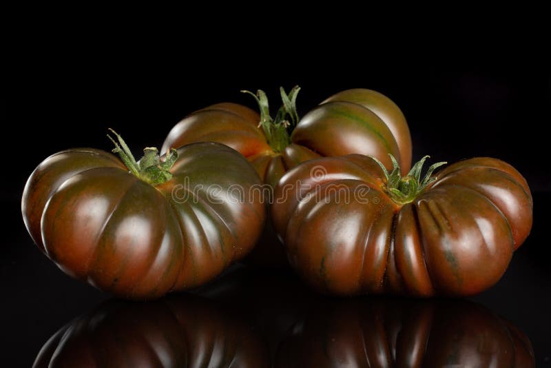 Fresh Dark Tomato Primora Isolated on Black Glass Stock Image - Image ...