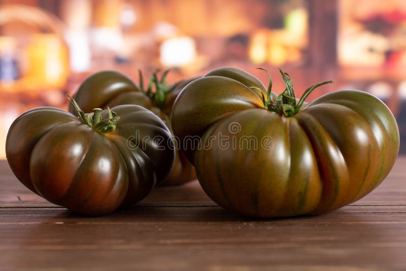 Fresh Dark Tomato Primora with Rustic Kitchen Stock Image - Image of ...