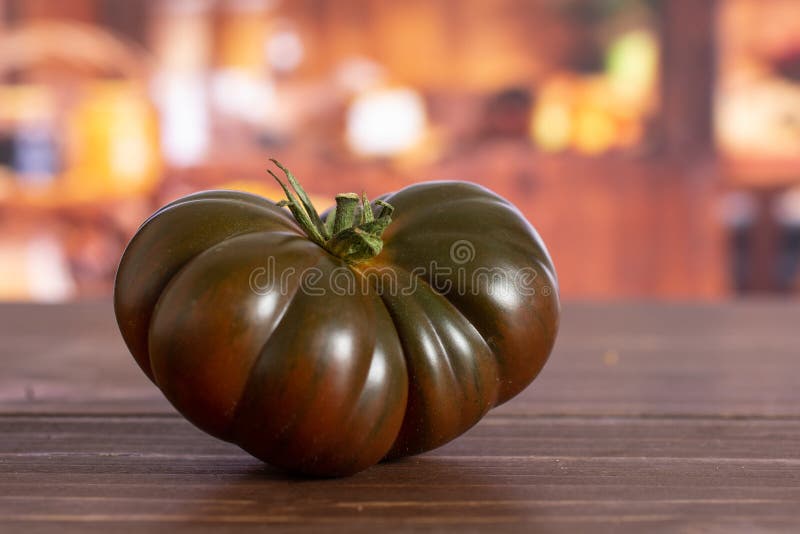 Fresh Dark Tomato Primora with Rustic Kitchen Stock Image - Image of ...