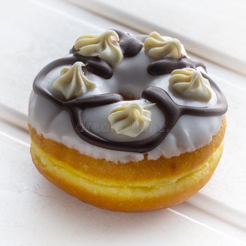 Fresh Donut Poured with Icing and Decorations, on a White Wooden Table ...