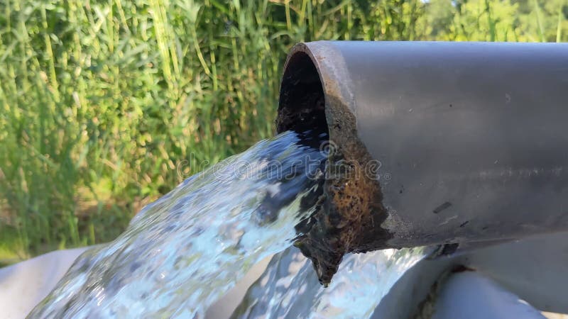 A Stream of Sewage Flows Out of a Plastic Sewer Pipe into the River ...