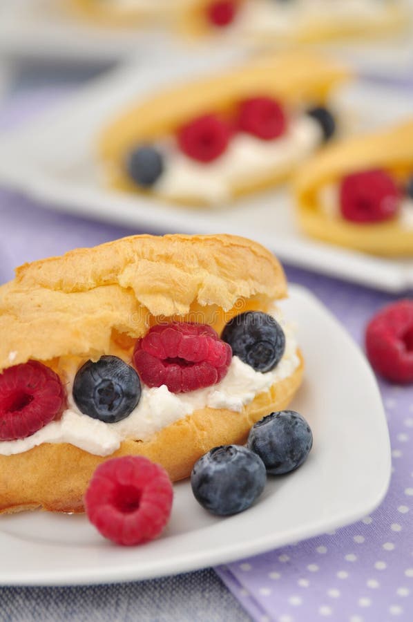 Fresh Eclairs with Whipped Cream and Berries Stock Image - Image of ...
