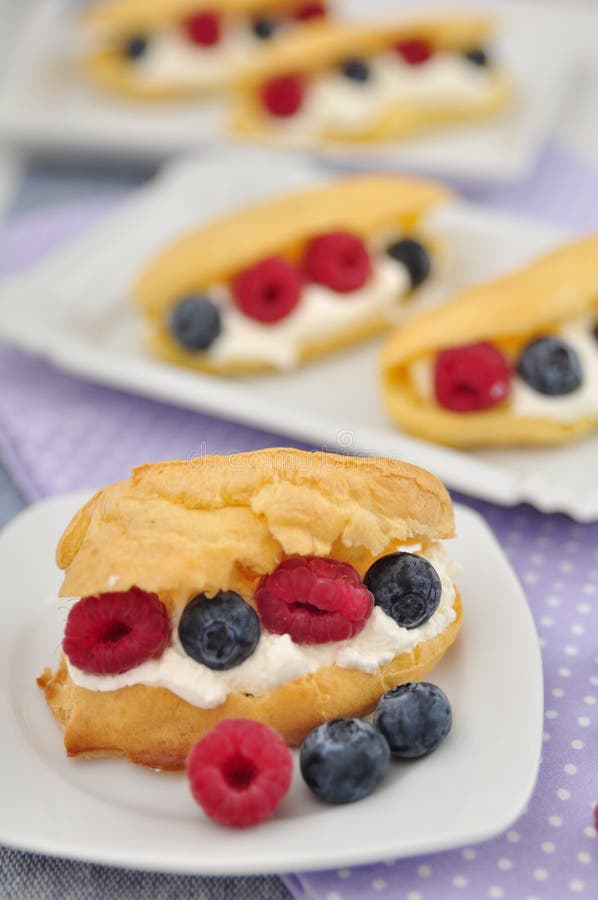 Fresh Eclairs with Whipped Cream and Berries Stock Photo - Image of ...