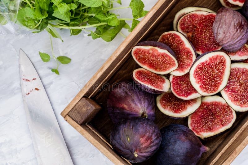 Fresh Figs in a Wooden Box with Mint on a Textured Concrete Gray ...