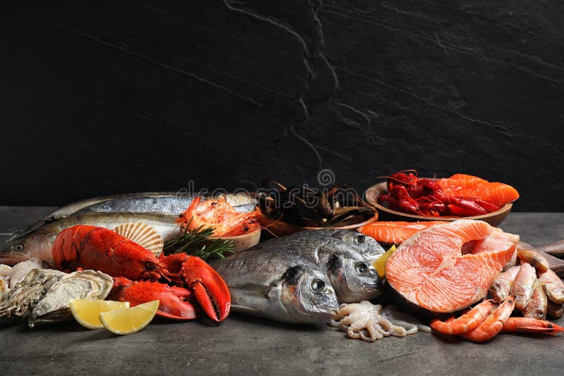 Fresh Fish and Different Seafood on Grey Table Stock Image - Image of ...