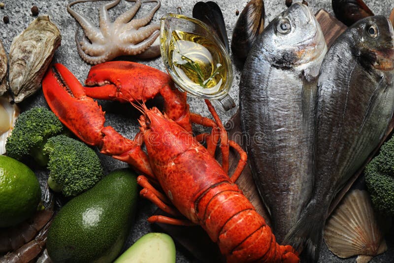 Fresh Fish and Different Seafood on Grey Table Stock Photo - Image of ...