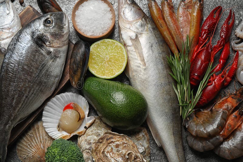Fresh Fish and Different Seafood on Grey Table Stock Photo - Image of ...