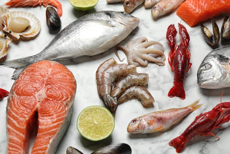 Fresh Fish and Different Seafood on White Marble Table Stock Image ...