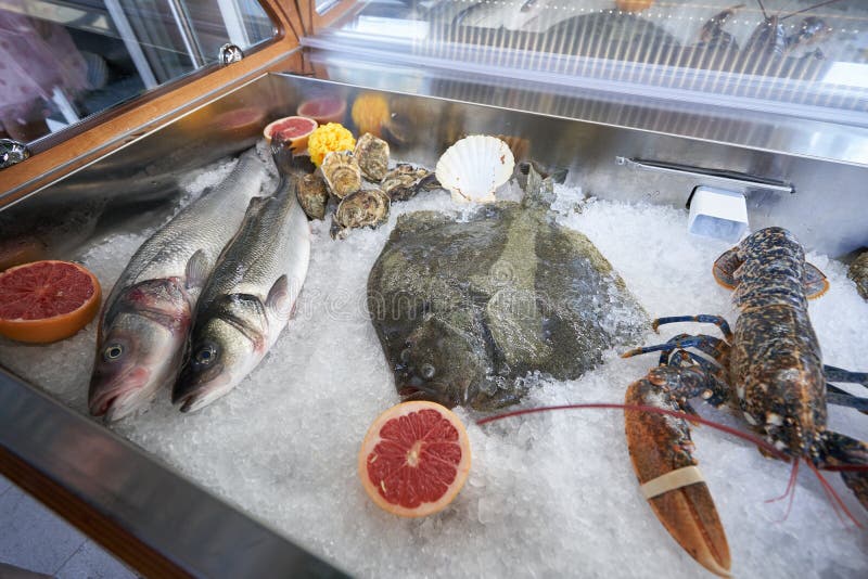 Fresh Fish Lie on Ice in the Display Fridge Stock Image - Image of ...