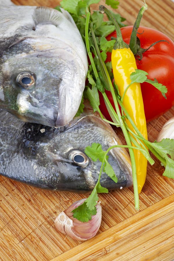 Fresh fish on a plate stock photo. Image of dish, vegetable - 210133826