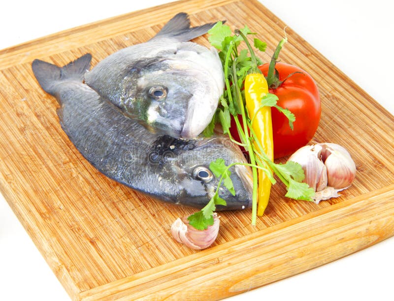 Fresh fish on a plate stock photo. Image of fish, cooking - 211295452