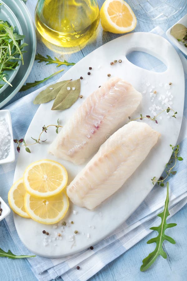 Fresh Fish, Raw Cod Fillets with Addition of Herbs and Lemon. Stock ...