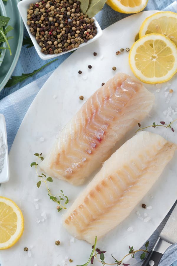 Fresh Fish, Raw Cod Fillets with Addition of Herbs and Lemon. Stock ...