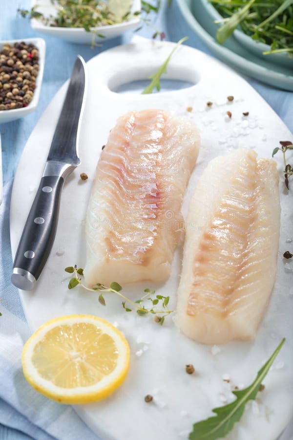 Fresh Fish, Raw Cod Fillets with Addition of Herbs and Lemon. Stock ...