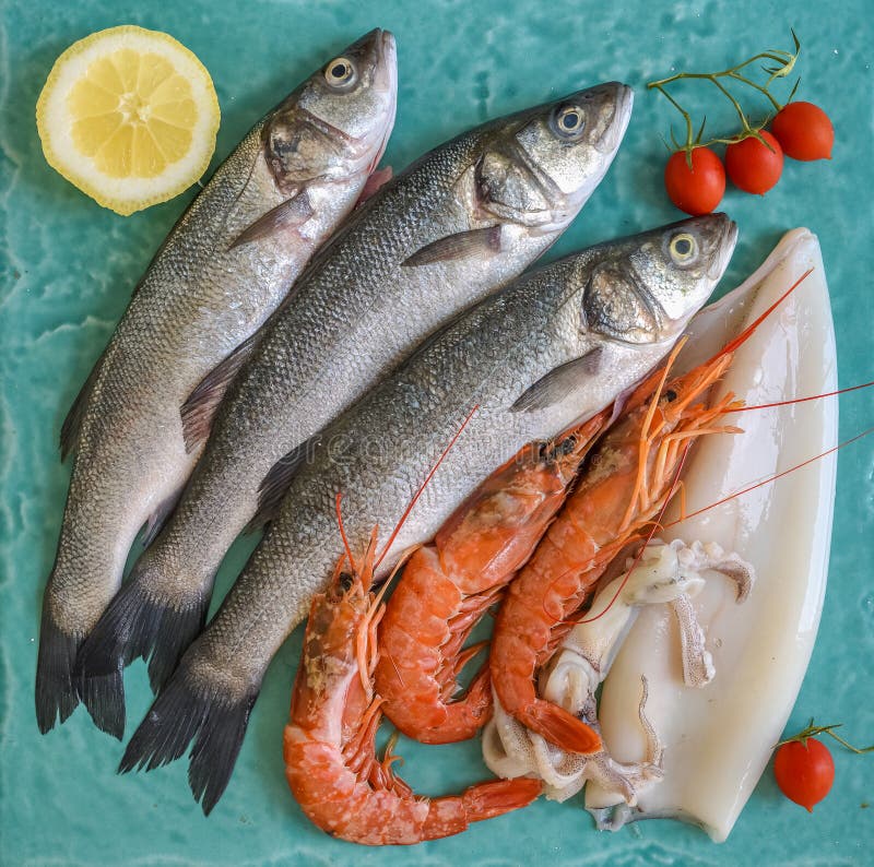 Fresh Fish, Shrimp and Squid on a Blue Marble Surface Stock Photo ...