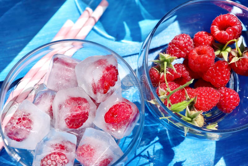 Fresh and Frozen Raspberries in Ice Cubes Stock Photo - Image of ...