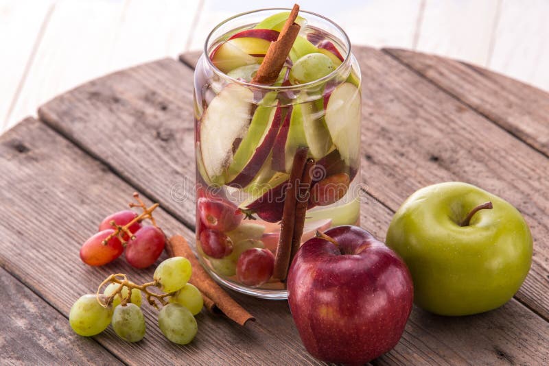 Fresh Fruit Flavored Infused Water Mix of Apple, Grape and Cinna Stock ...