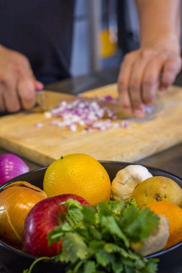 Fresh Fruit in the Kitchen with Chef Cutting Onion To Prepare Food ...