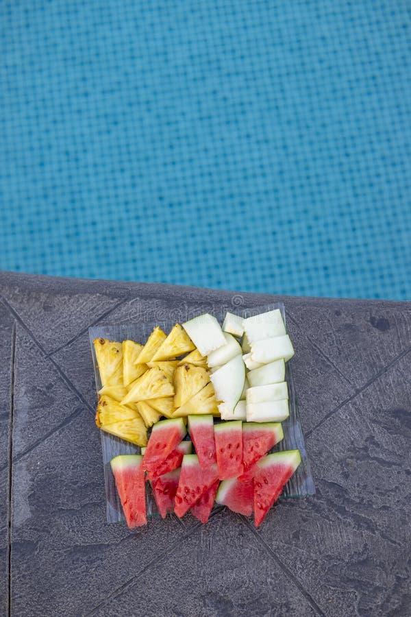 Fresh Fruit Platter on the Stamped Concrete by the Pool, Healthy Diet ...
