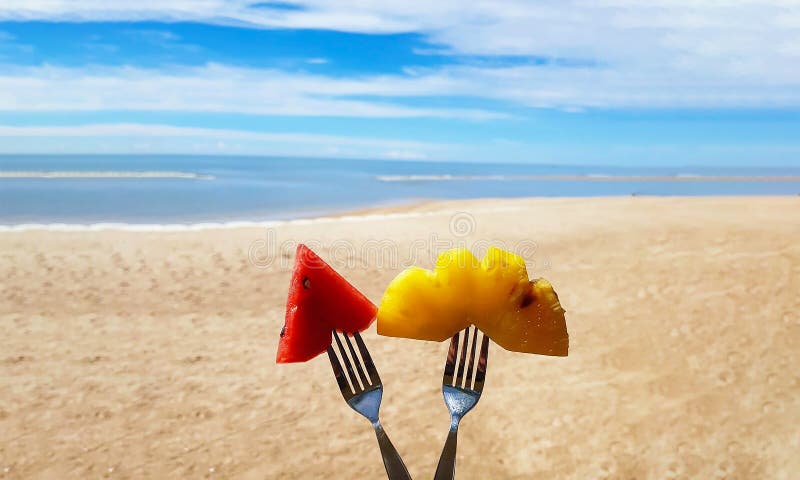 Fresh Fruits on the Beach on Fork in Front of an Island. Assorted ...