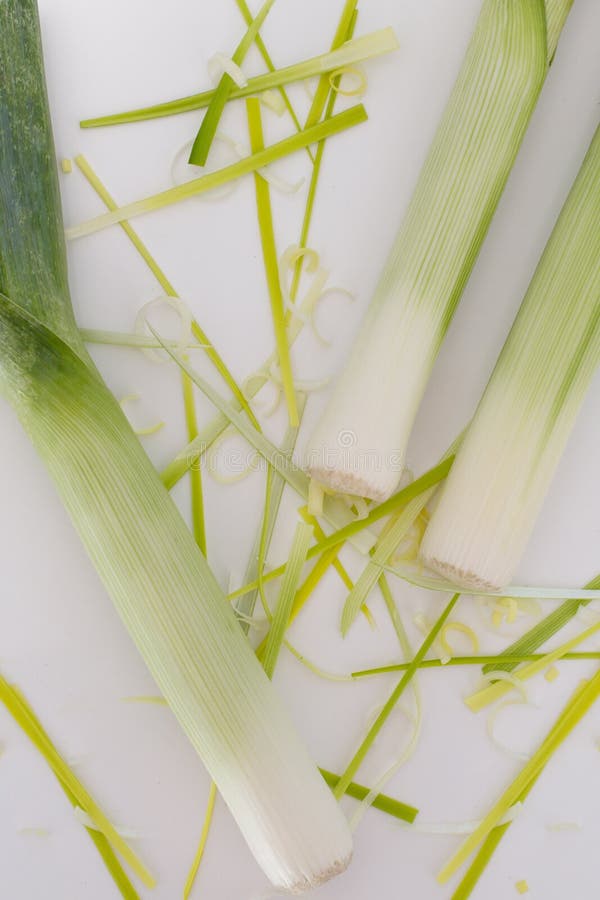 Fresh Green Leeks with Leeks Cuttings in a White Background Stock Photo ...