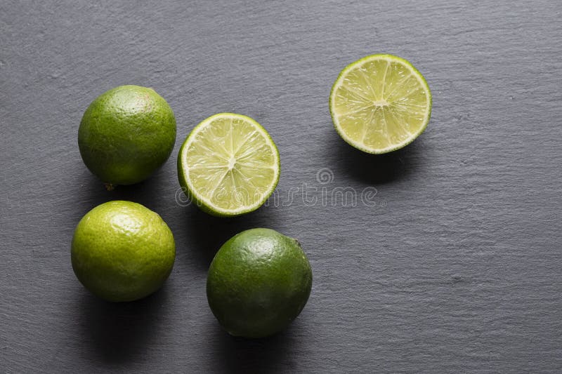 Fresh Green Limes on a Black Slate Background Stock Image - Image of ...