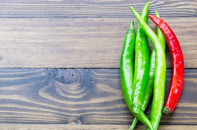 A Fresh Green and Red Chilli on Wooden Background Stock Image - Image ...